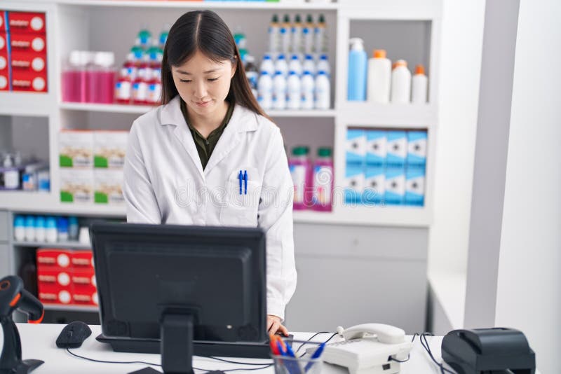 Chinese Woman Pharmacist Using Computer Working at Pharmacy Stock Photo ...