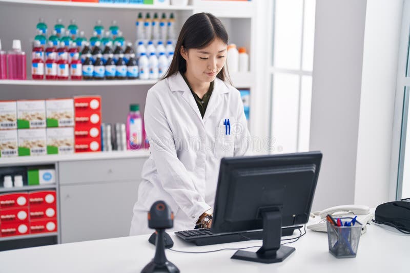 Chinese Woman Pharmacist Using Computer Working at Pharmacy Stock Photo ...