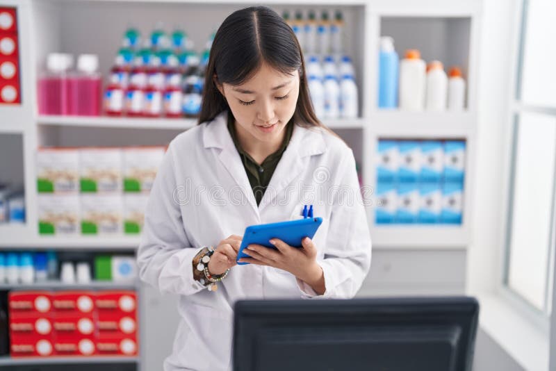 Chinese Woman Pharmacist Using Touchpad Working at Pharmacy Stock Image ...