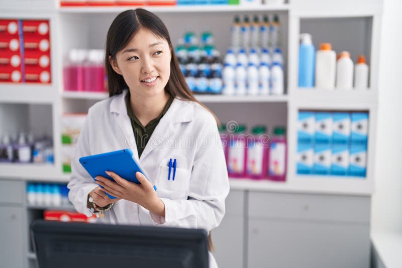 Chinese Woman Pharmacist Using Touchpad Working at Pharmacy Stock Image ...