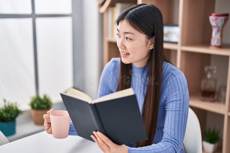 Chinese Woman Reading Book and Drinking Coffee at Home Stock Image ...