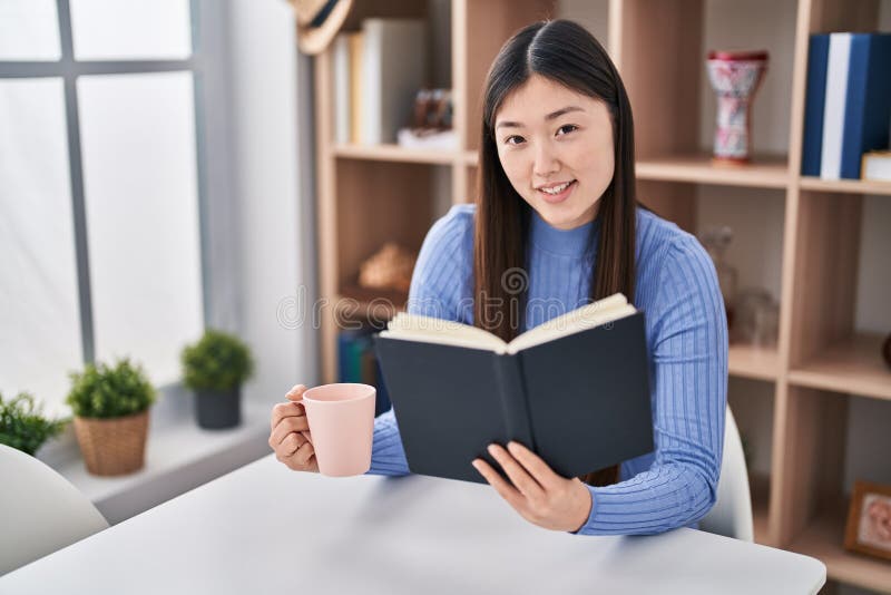 Chinese Woman Reading Book and Drinking Coffee at Home Stock Photo ...