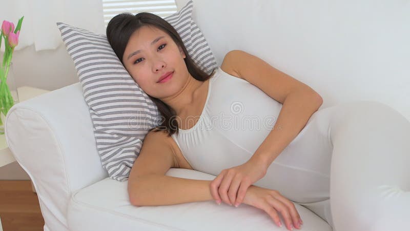 Chinese Woman Moving Her Legs on Couch Stock Footage - Video of sofa ...