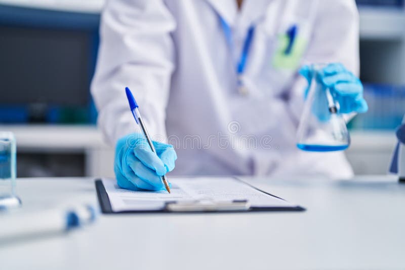 Chinese Woman Scientist Measuring Liquid Writing on Document at ...