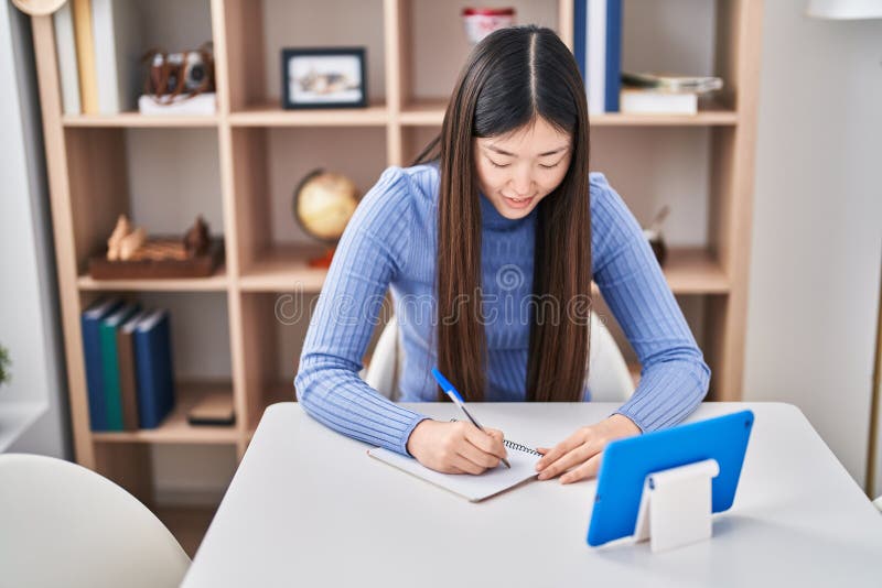 Chinese Woman Writing on Notebook Sitting on Table at Home Stock Image ...
