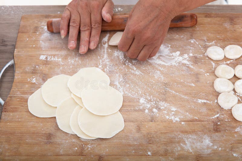 Chinese Women in the Kitchen are Rolling Out Dumpling Skins and ...