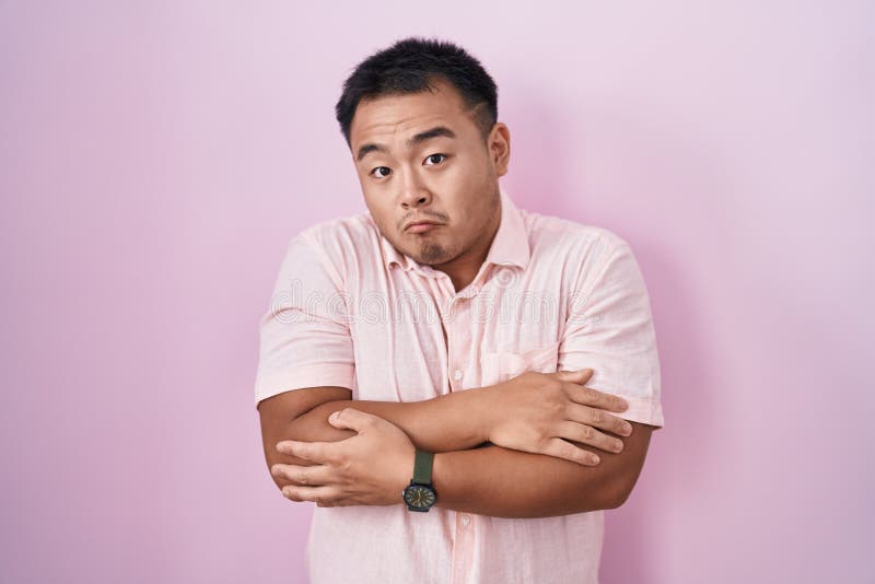 Chinese Young Man Standing Over Pink Background Shaking and Freezing ...