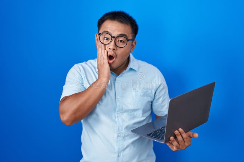 Chinese Young Man Using Computer Laptop Afraid and Shocked, Surprise ...