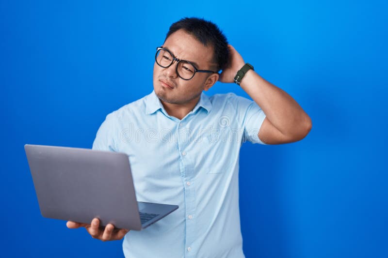 Chinese Young Man Using Computer Laptop Confuse and Wondering about ...