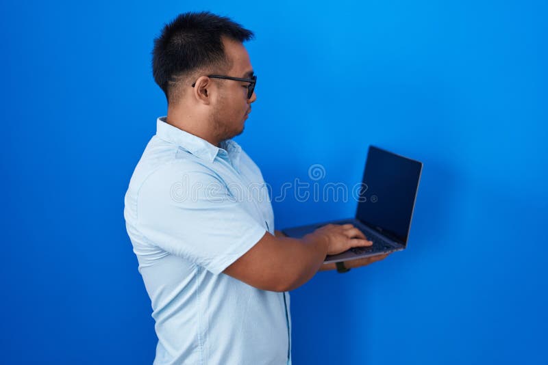 Chinese Young Man Using Computer Laptop Looking To Side, Relax Profile ...