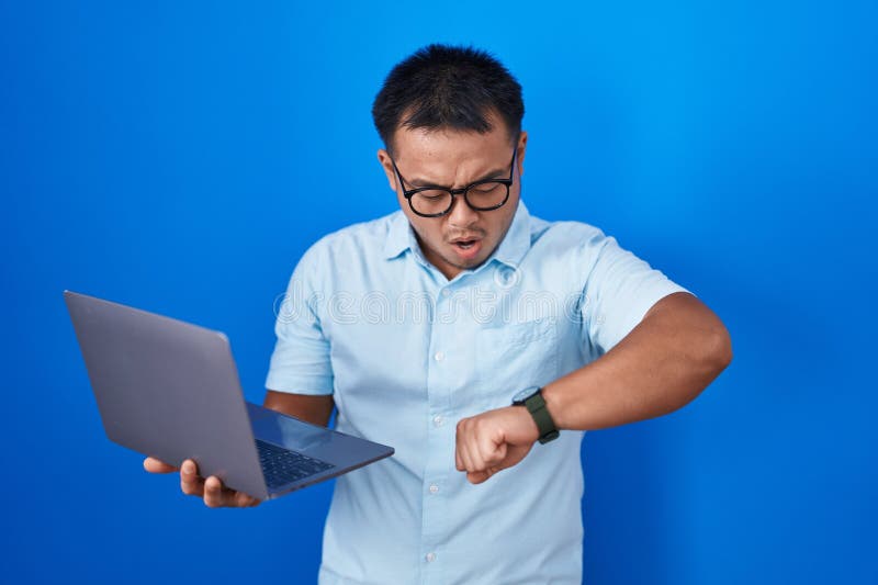 Chinese Young Man Using Computer Laptop Looking at the Watch Time ...