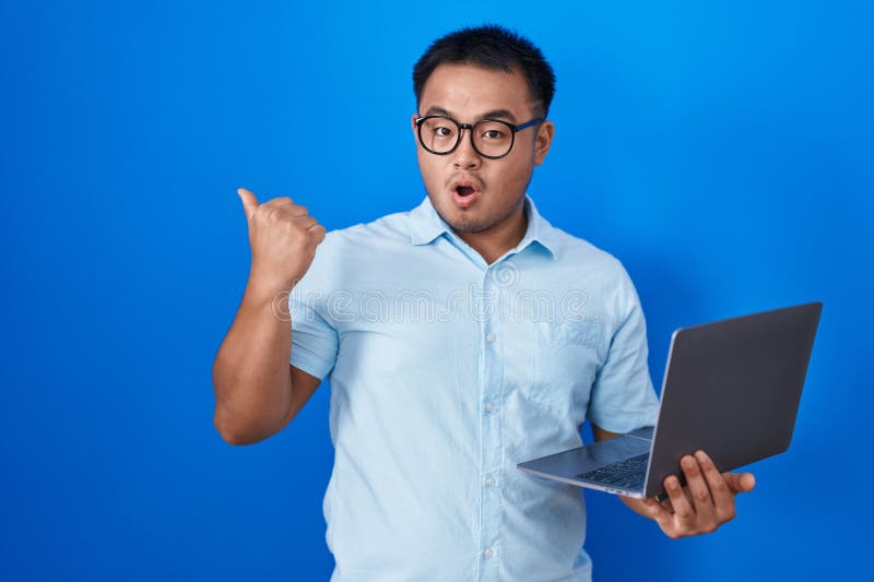 Chinese Young Man Using Computer Laptop Surprised Pointing with Hand ...