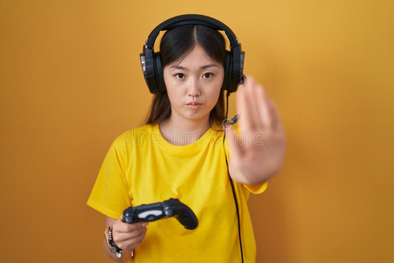 Chinese Young Woman Playing Video Game Holding Controller Doing Stop ...