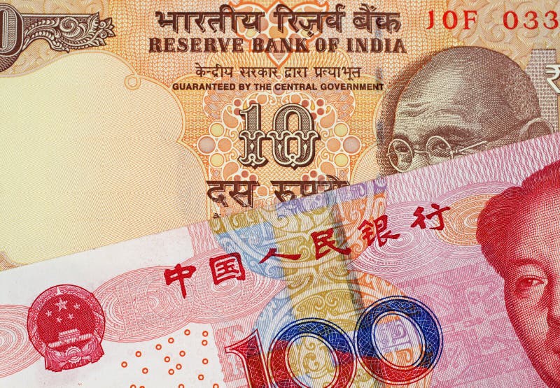 An Indian Ten Rupee Bank Note with an American One Hundred Dollar Bill ...