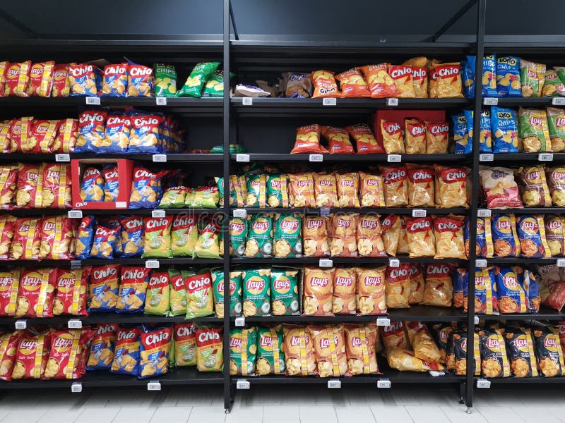 Chips of Different Flavors on the Shelf in the Supermarket Editorial ...