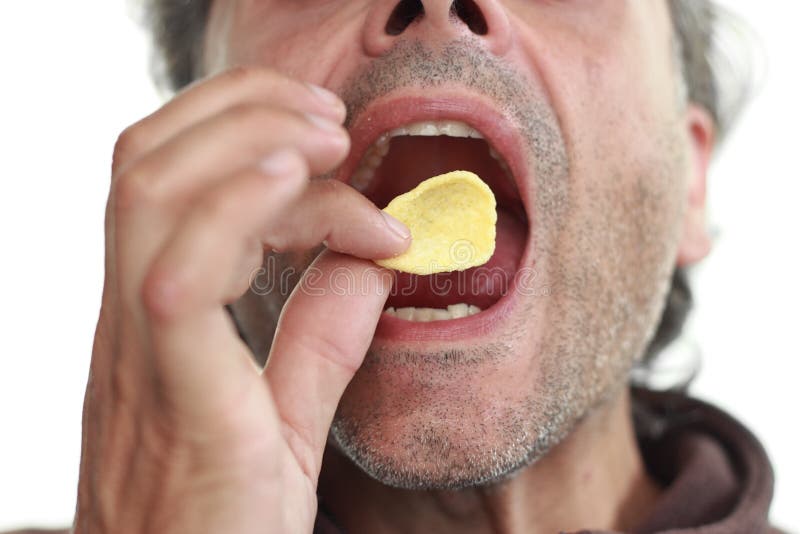 Eating Snacks. Close-up of Men Eating Potato Chip Stock Image - Image ...