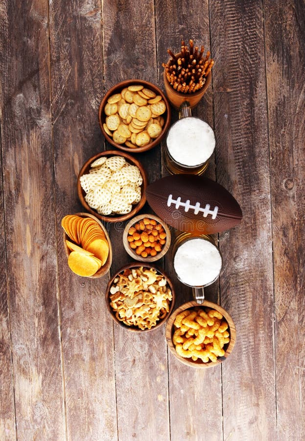Chips, Salty Snacks, Football and Beer on a Table. Great for Bowl Game ...