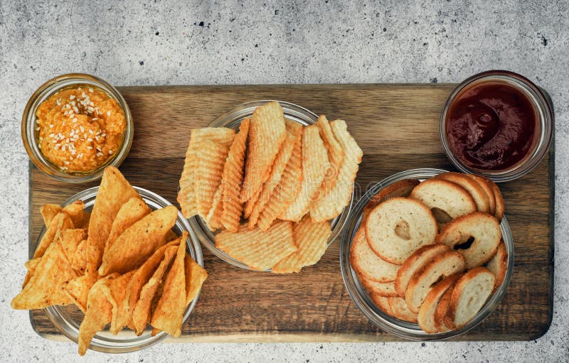 Chips, Snacks and Crackers on a Wooden Board. Snack Food. Stock Image ...