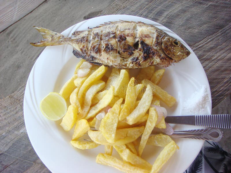 Chipsy Samaki Chips with Fried Fish and Salt on White Dish Stock Photo ...