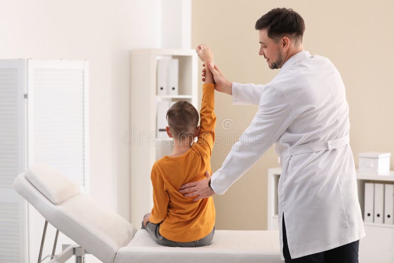 Chiropractor Examining Child with Back Pain Stock Image - Image of ...