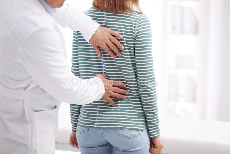 Chiropractor Examining Patient with Back Pain in Clinic Stock Image ...