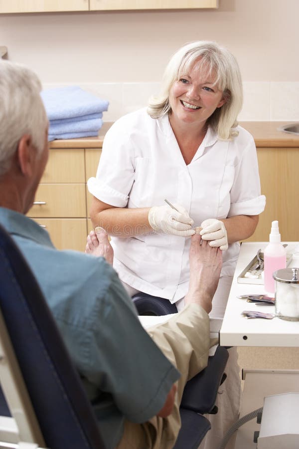 Chirpodist Treating Client in Clinic Stock Photo - Image of seventies ...