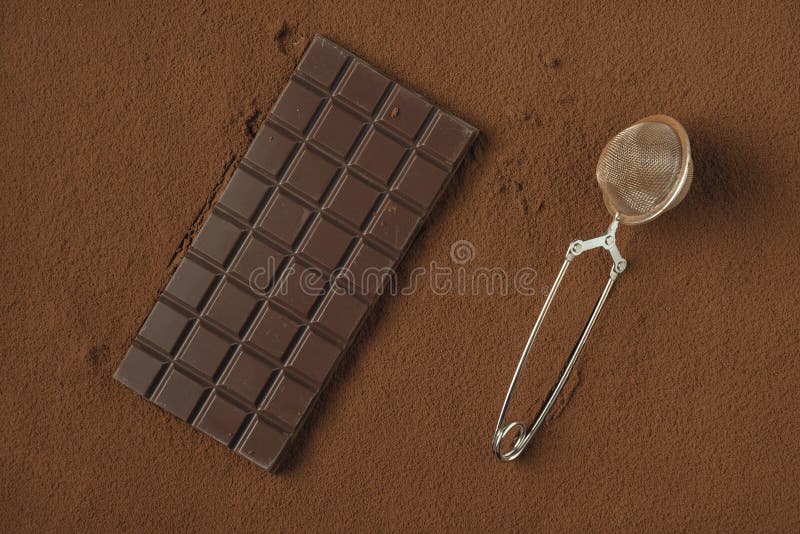 Chocolate Bar and Strainer on Cocoa Powder Background Stock Photo ...