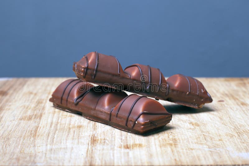 Chocolate Bars on a Wooden Base on a Gray-blue Background Stock Photo ...