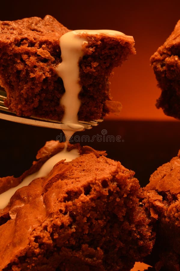 Forkful of Brownie Dripping with Creamy Icing Stock Photo - Image of ...