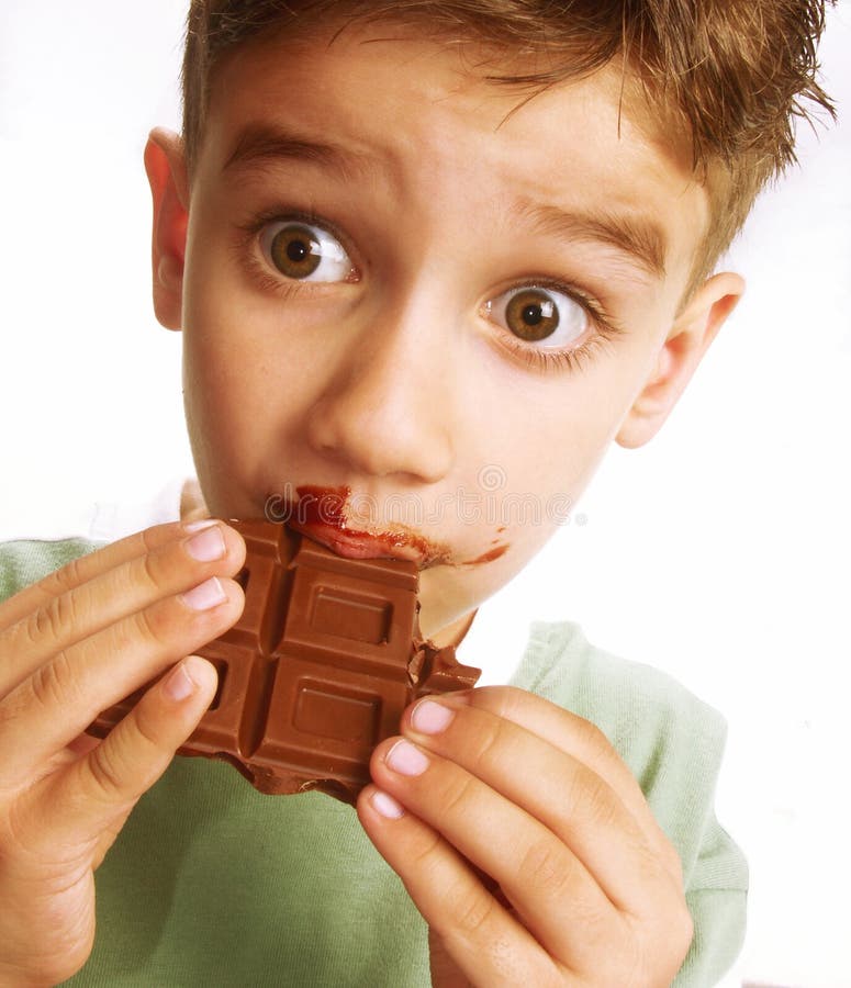Cute boy eating chocolate stock image. Image of sugar - 16971583