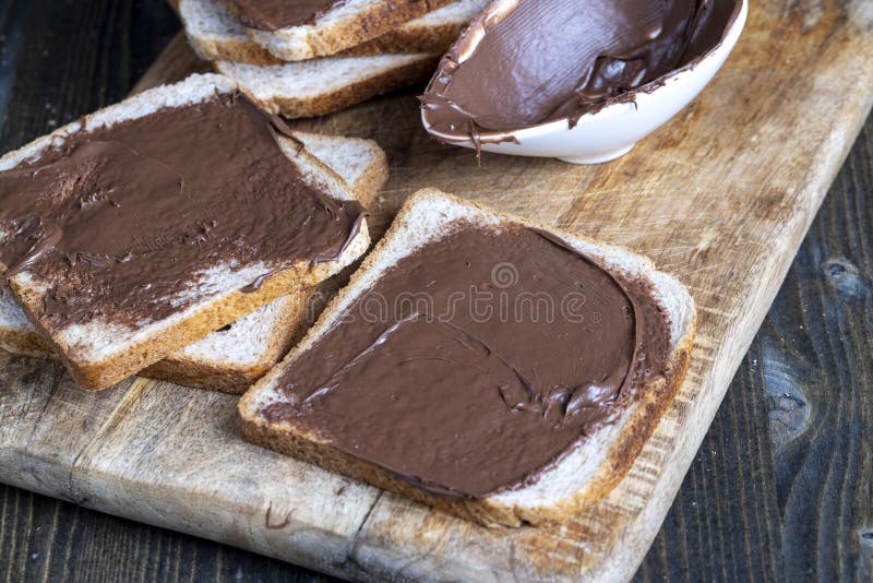 Chocolate Butter Spread on Bread while Cooking Breakfast Stock Photo ...