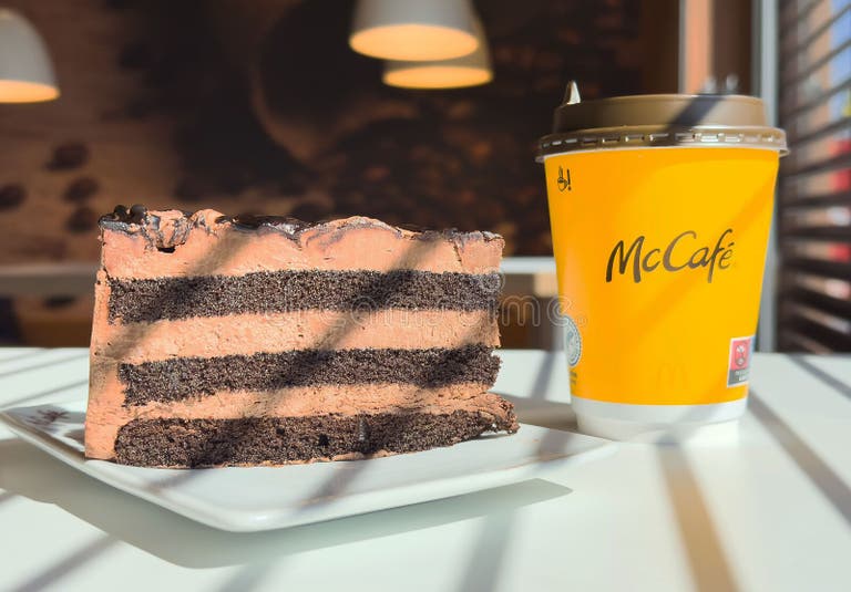 Chocolate Cake and Coffee Cup on Sunlit Table at Mccafe Editorial ...