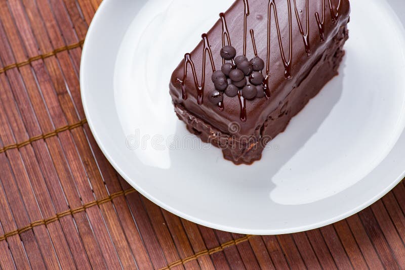 Chocolate cake on plate stock photo. Image of glaze - 125733154
