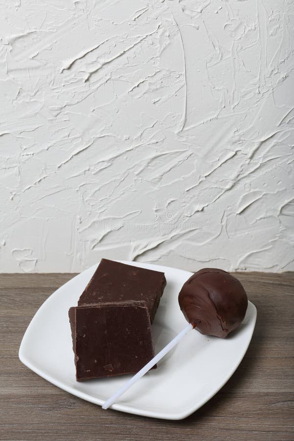 Chocolate Cake Pops and Pieces of Black Chocolate on a White Plate. on ...