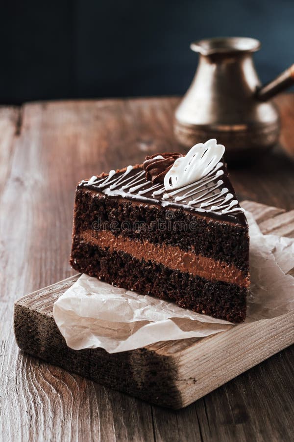 Chocolate Cake Side View on a Cutting Board Rustic on a Wooden Table ...