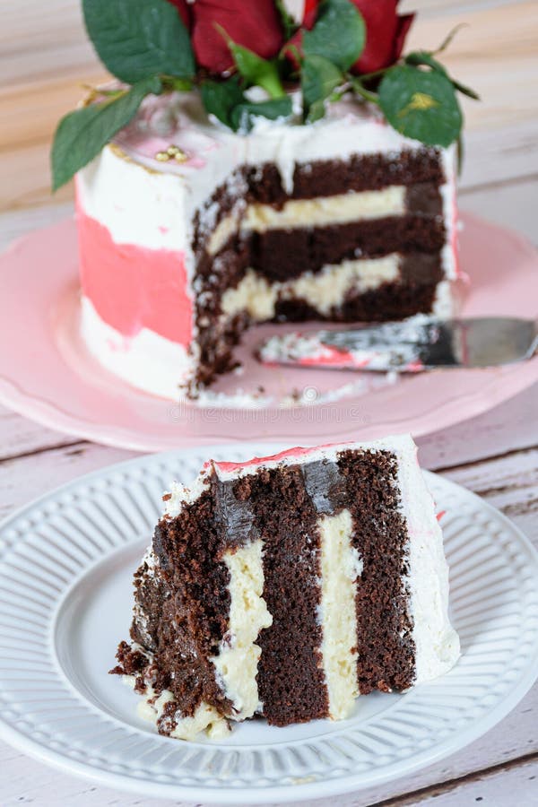 Chocolate Cake Slice With Mascarpone Filling In The Blurred Background Cake Covered With Swiss
