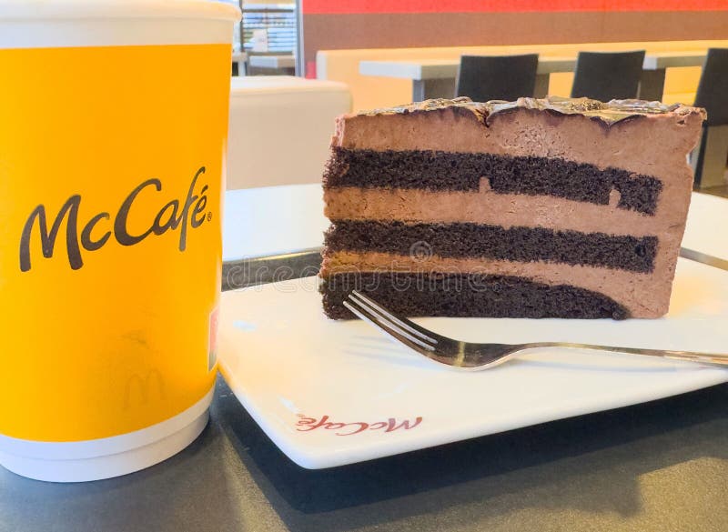 Chocolate Cake Slice with Mccafe Coffee Cup on Table Setting Editorial ...