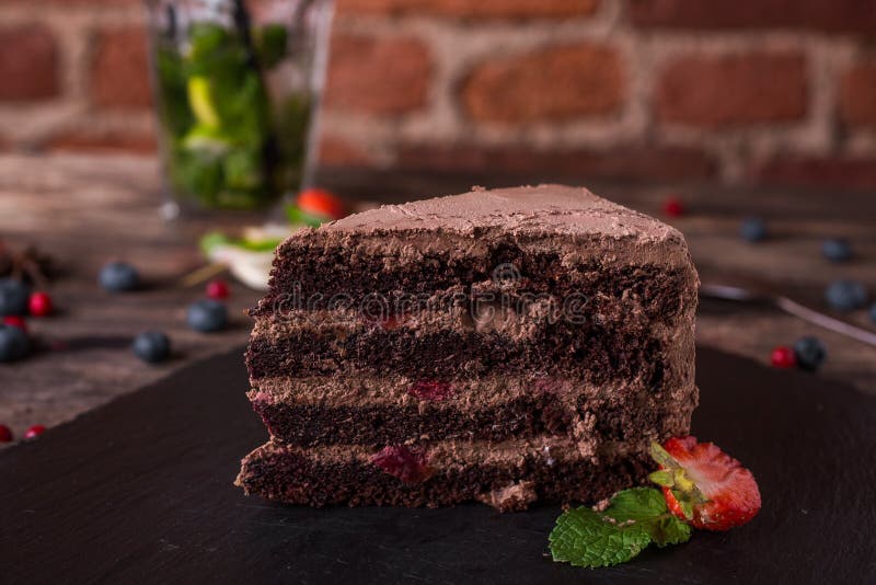 Chocolate Cake on a Stone Plate on Rustic Wood Table Stock Image ...