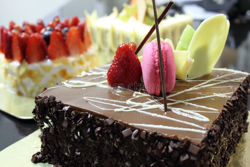 Chocolate Cake Topped with a Strawberry and Macaron Stock Image - Image ...