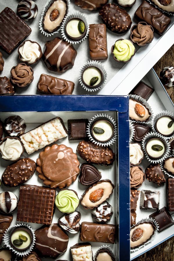 Chocolate candies in boxes stock image. Image of table - 107298731