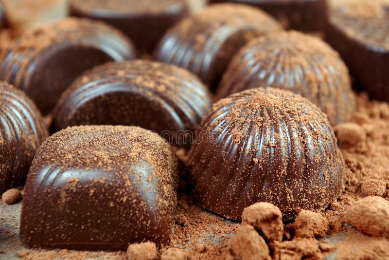 Chocolate Candies and Cocoa Powder on the Table. Stock Photo - Image of ...
