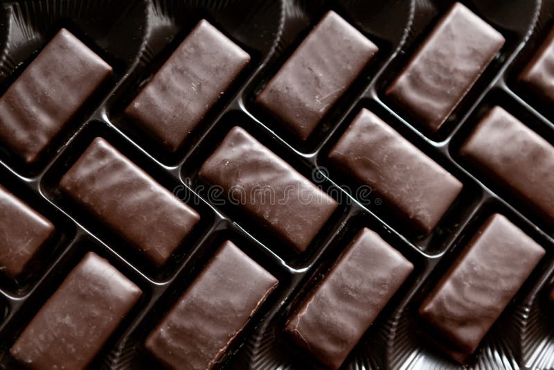 Chocolate candies in a row stock image. Image of confectionery - 236446071