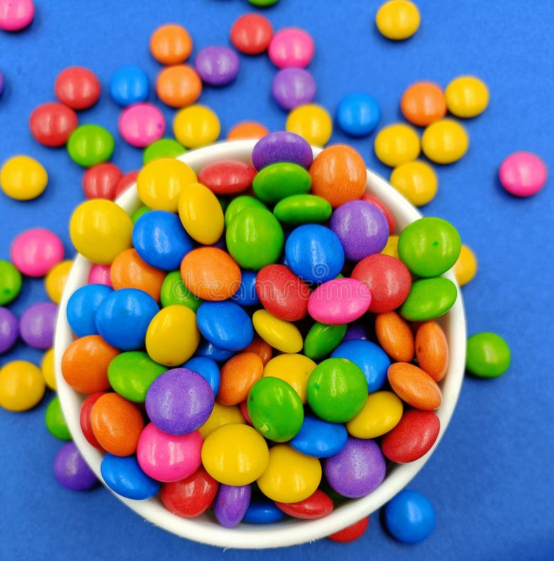 Chocolate Candy Gems on Blue Stock Image - Image of candy, delicious ...