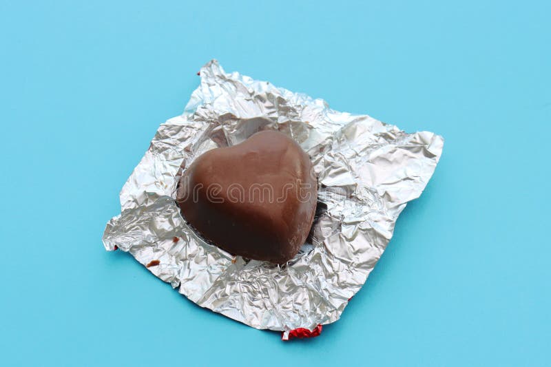 Chocolate Candy with Wrapper on a Blue Background. Stock Photo - Image ...