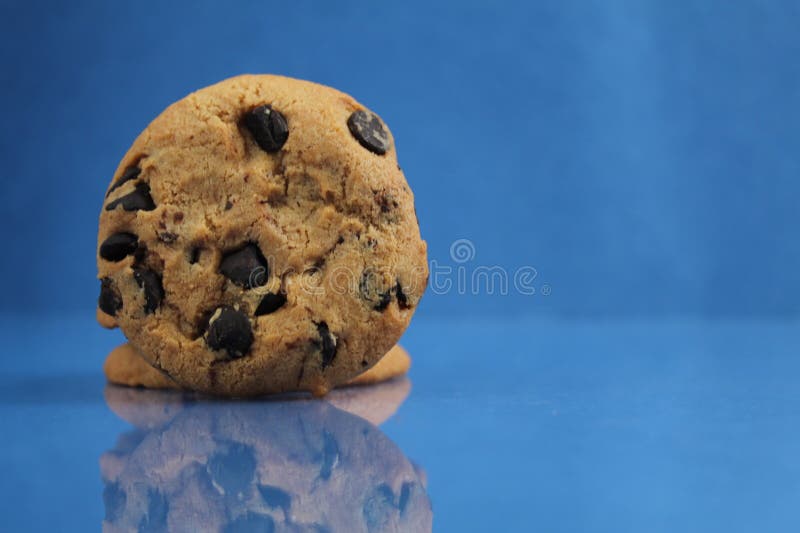 Chocolate Chip Cookie on a Blue Background with Space for Copyspace ...