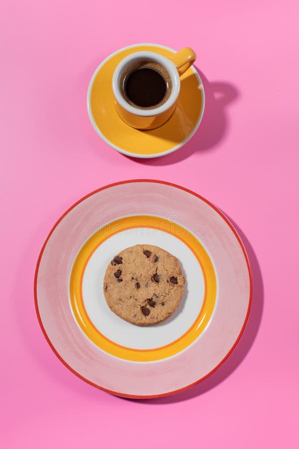 Chocolate Chip Cookie on a Bright Plate, Pink Backdrop with a Cup of ...