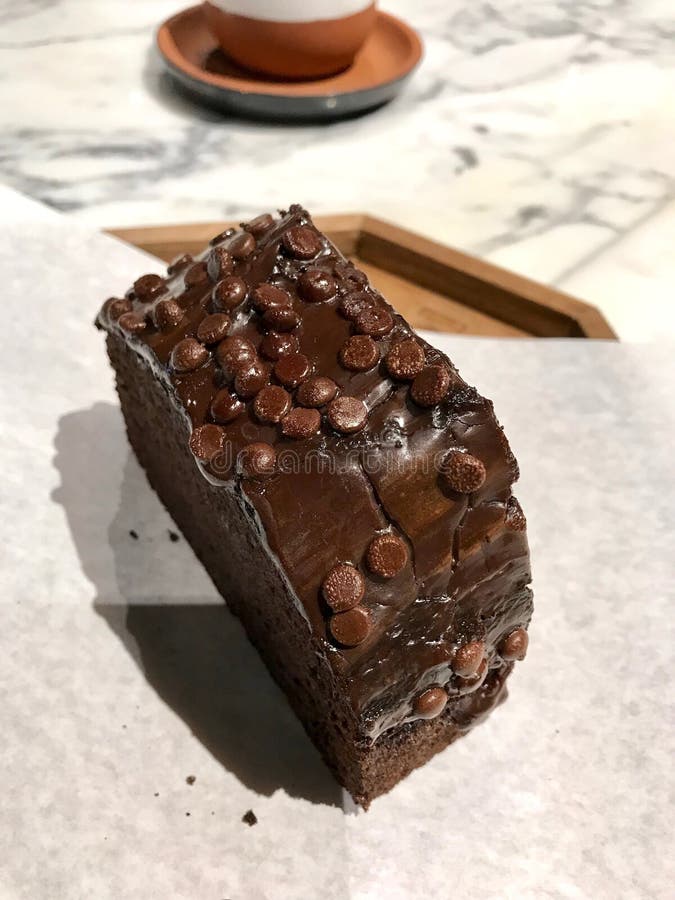 Chocolate Chip Sponge Cake Slice with Coffee on Marble Surface Stock ...