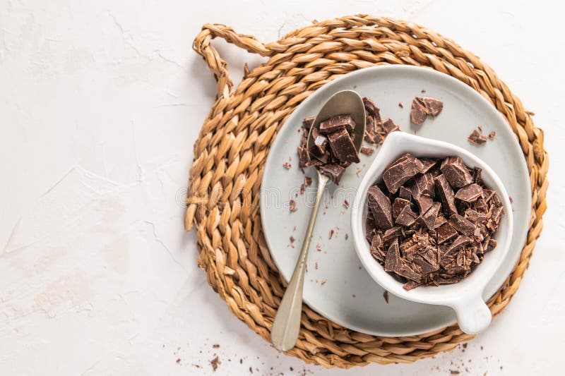 Chocolate Chunks in a White Bowl on a White Plate, Placed on a Woven ...