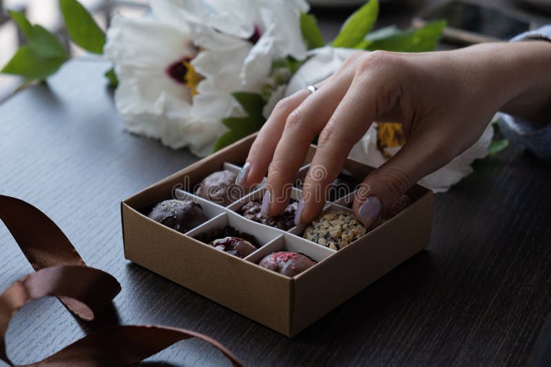 Chocolate Craft Candy in Female Hand and Candy Box Stock Image - Image ...
