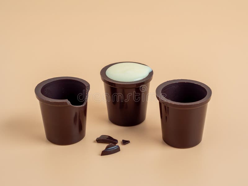Chocolate Cup Filled with White Pudding on an Orange Background ...